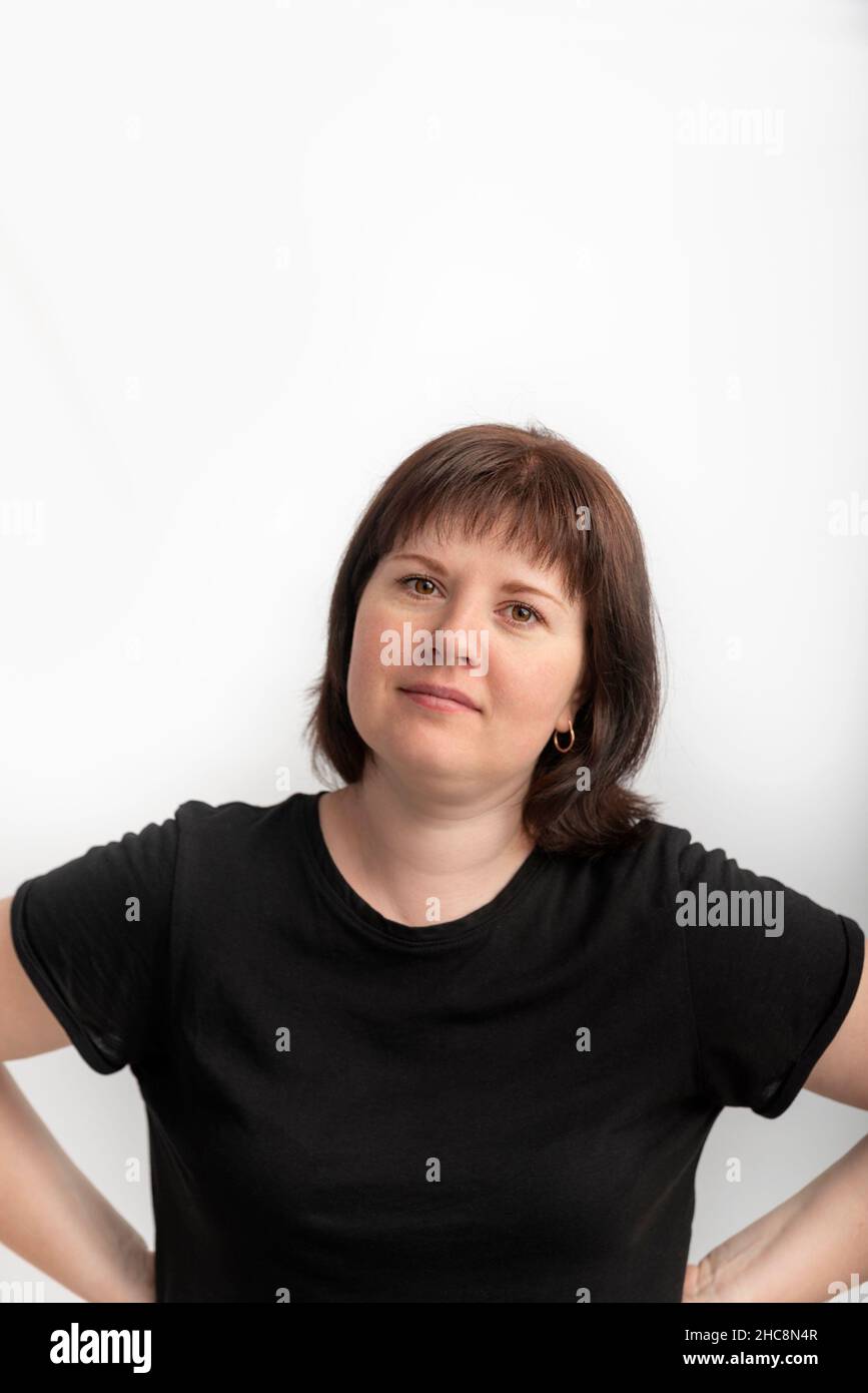 Portrait of round-faced middle-aged woman with dark hair and bangs ...