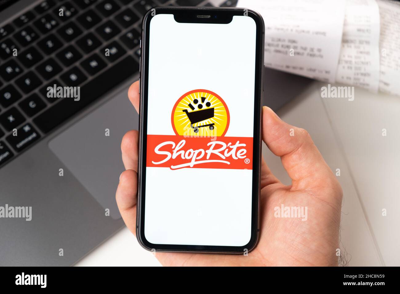 ShopRite application on the screen of Apple iPhone in mans hand and ...