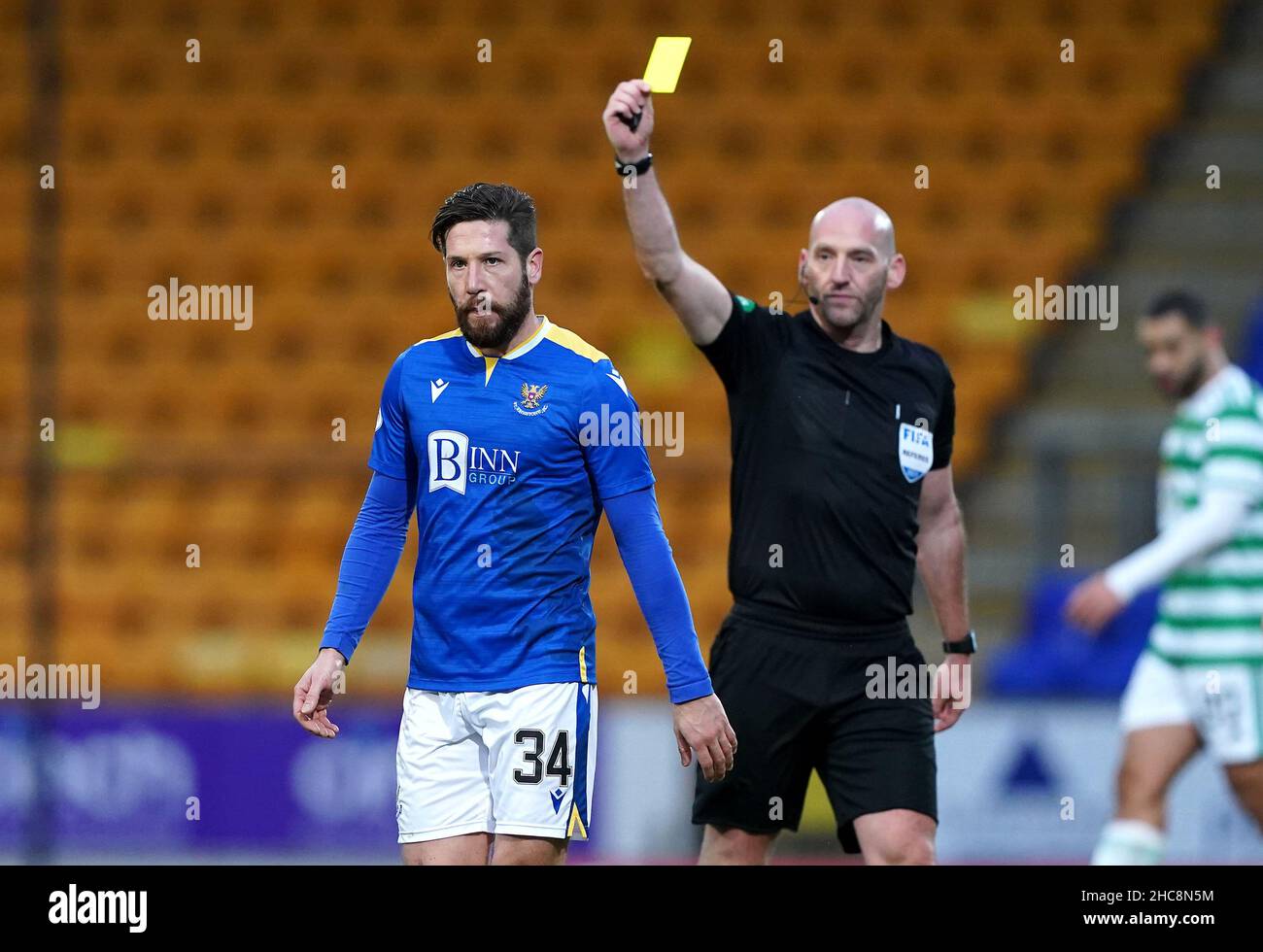 St Johnstone's Jacob Butterfield (left) is shown a yellow card by ...