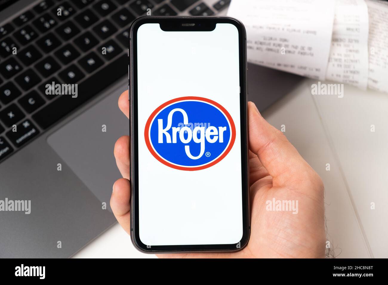 Kroger application on the screen of Apple iPhone in mans hand and ...