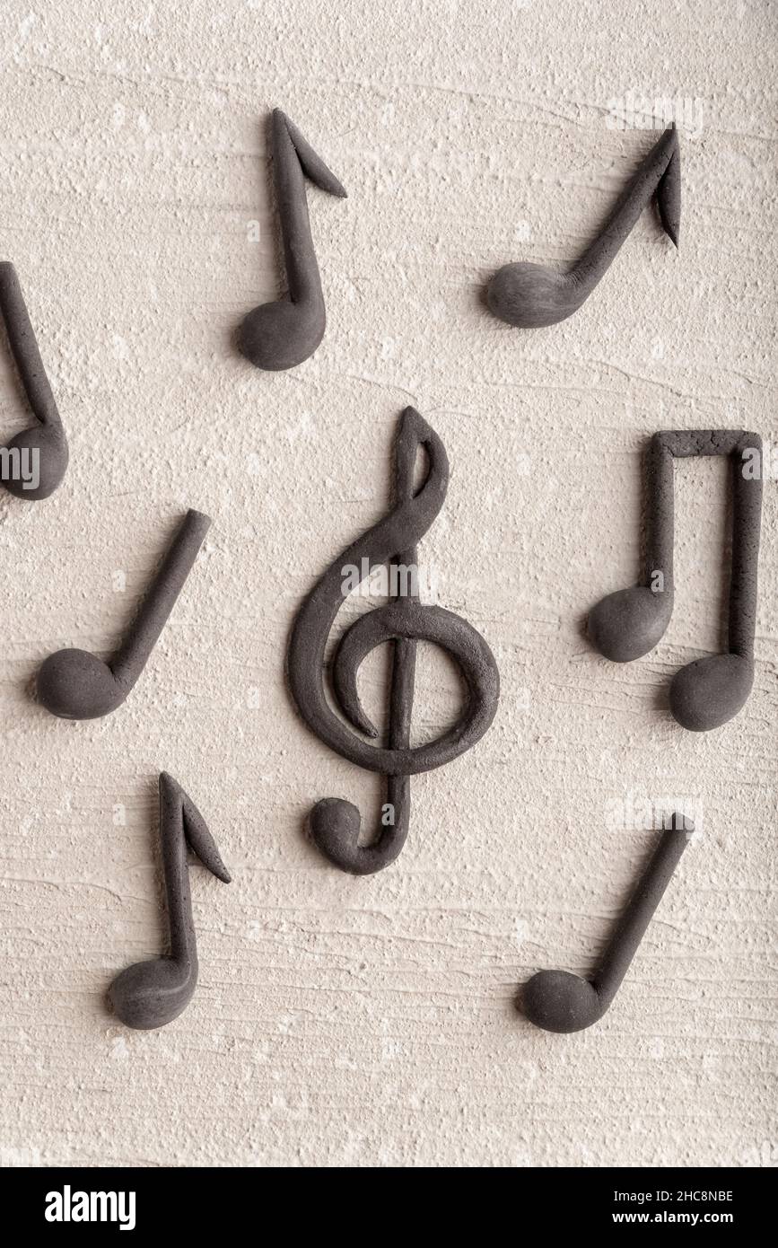 Treble clef and musical notes on beige background. Violin key. CLose up ...