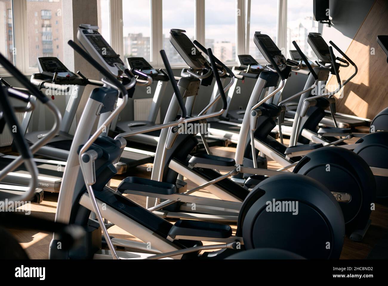 Interior of the modern gym with large windows. Elliptical trainers ...