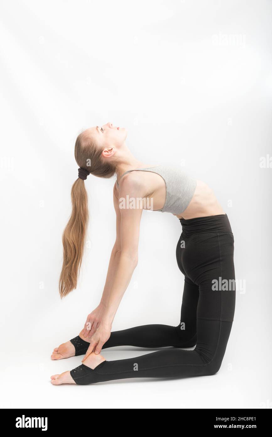 Camel Pose. Ustrasana. Young attractive woman practicing yoga. Slender ...