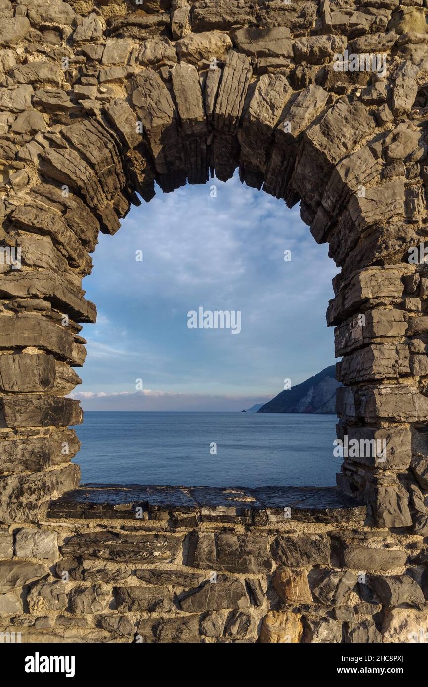Sea shore seen through stone arch window. Italy, Liguria, Portovenere ...