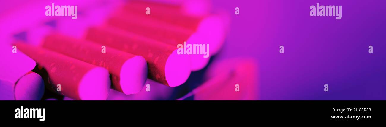 Open pack of cigarettes with close-up of several stretched cigarettes ...