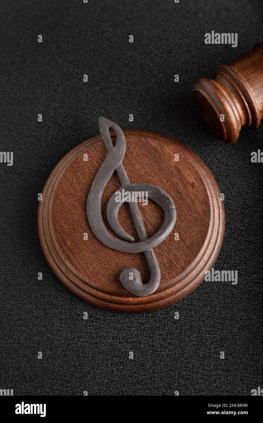 Music symbol treble clef and judge gavel on black background. Music ...