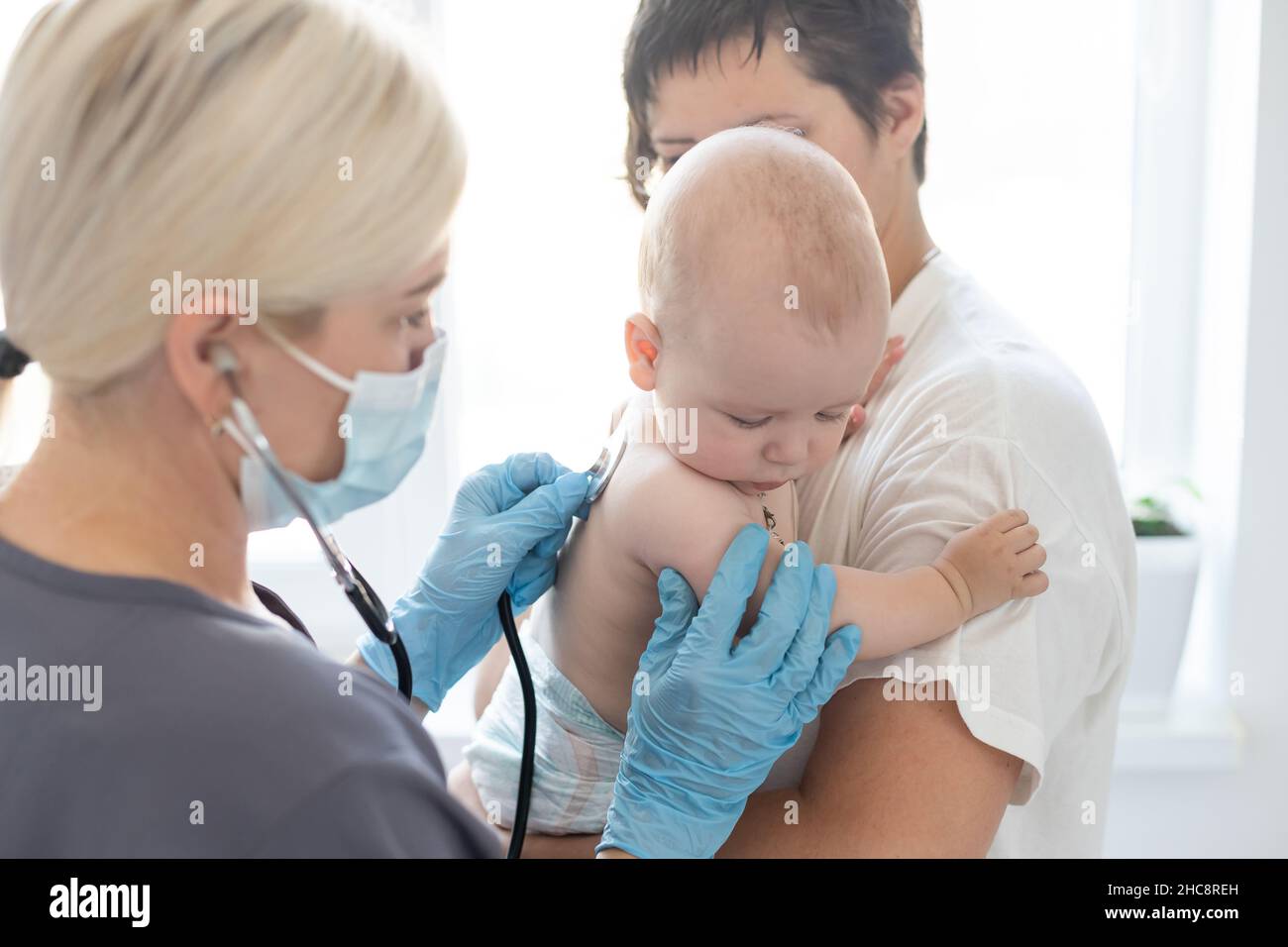 Doctor giving baby girl checkup in doctor office Stock Photo - Alamy