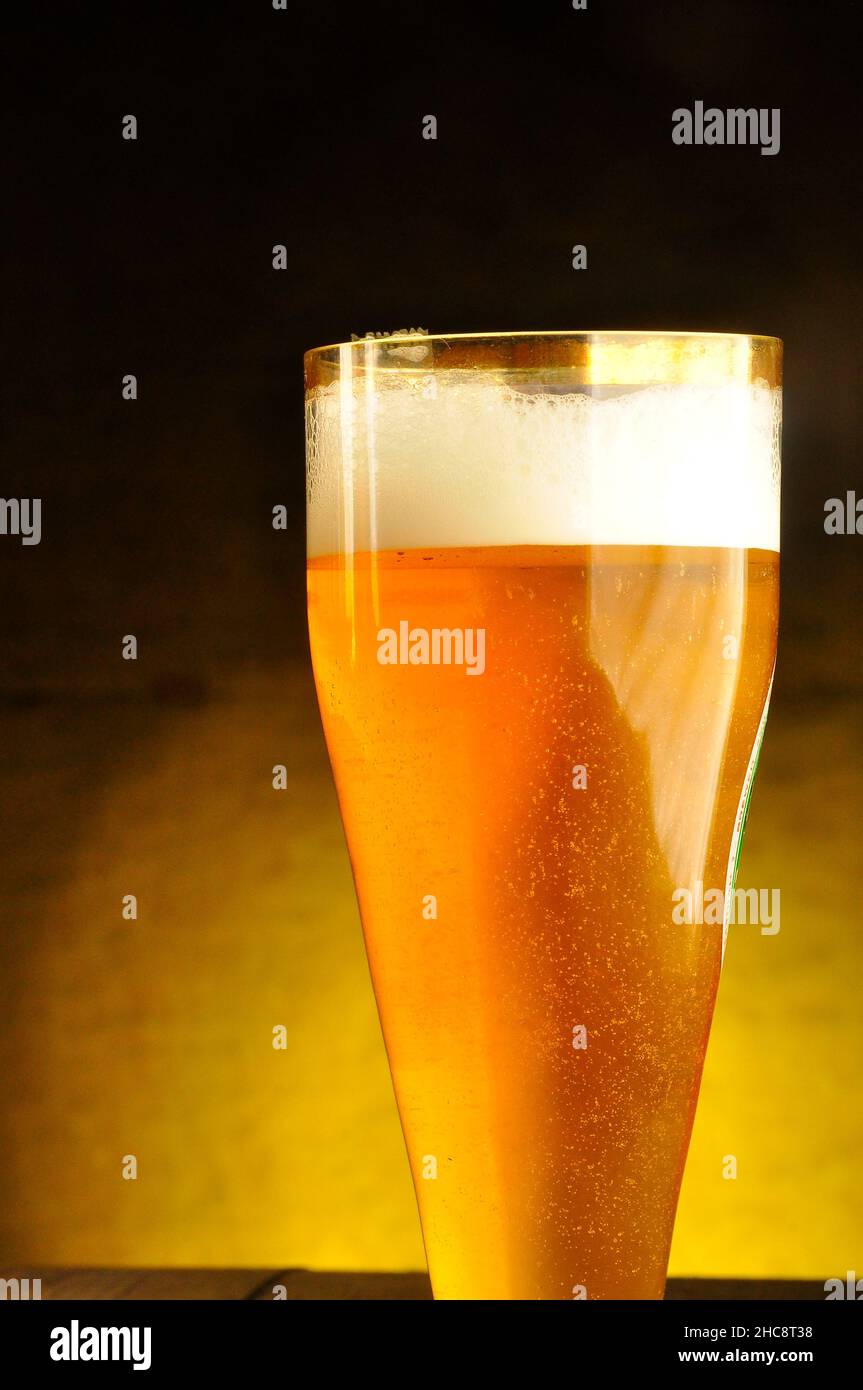 Still life of glass of beer over yelow background Stock Photo - Alamy