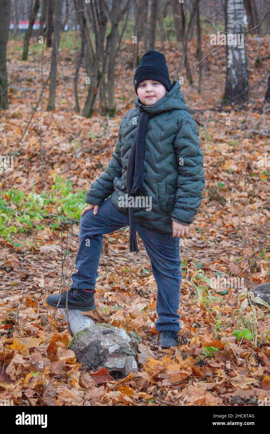 The boy is standing in the autumn park Stock Photo - Alamy