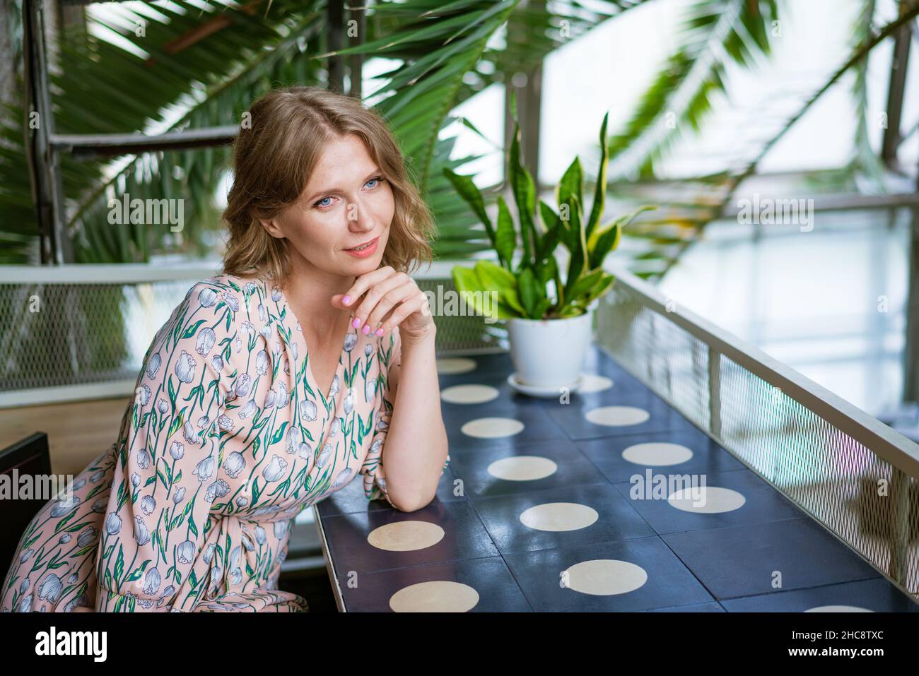 Portrait charming woman is calling, sitting alone in cafe in her free ...