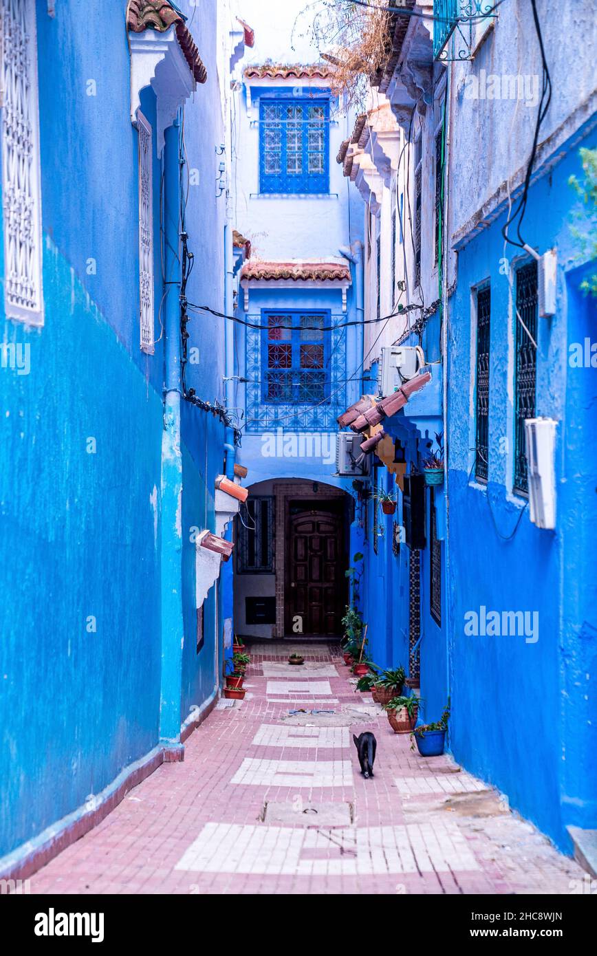 Narrow alley of blue town with residential structures on both side ...