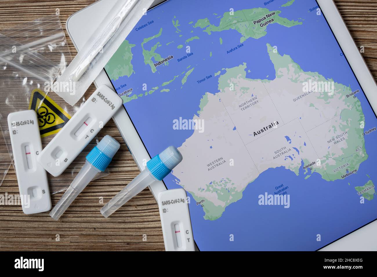 Covid home testing kits laying on a table next to a map of Australia ...