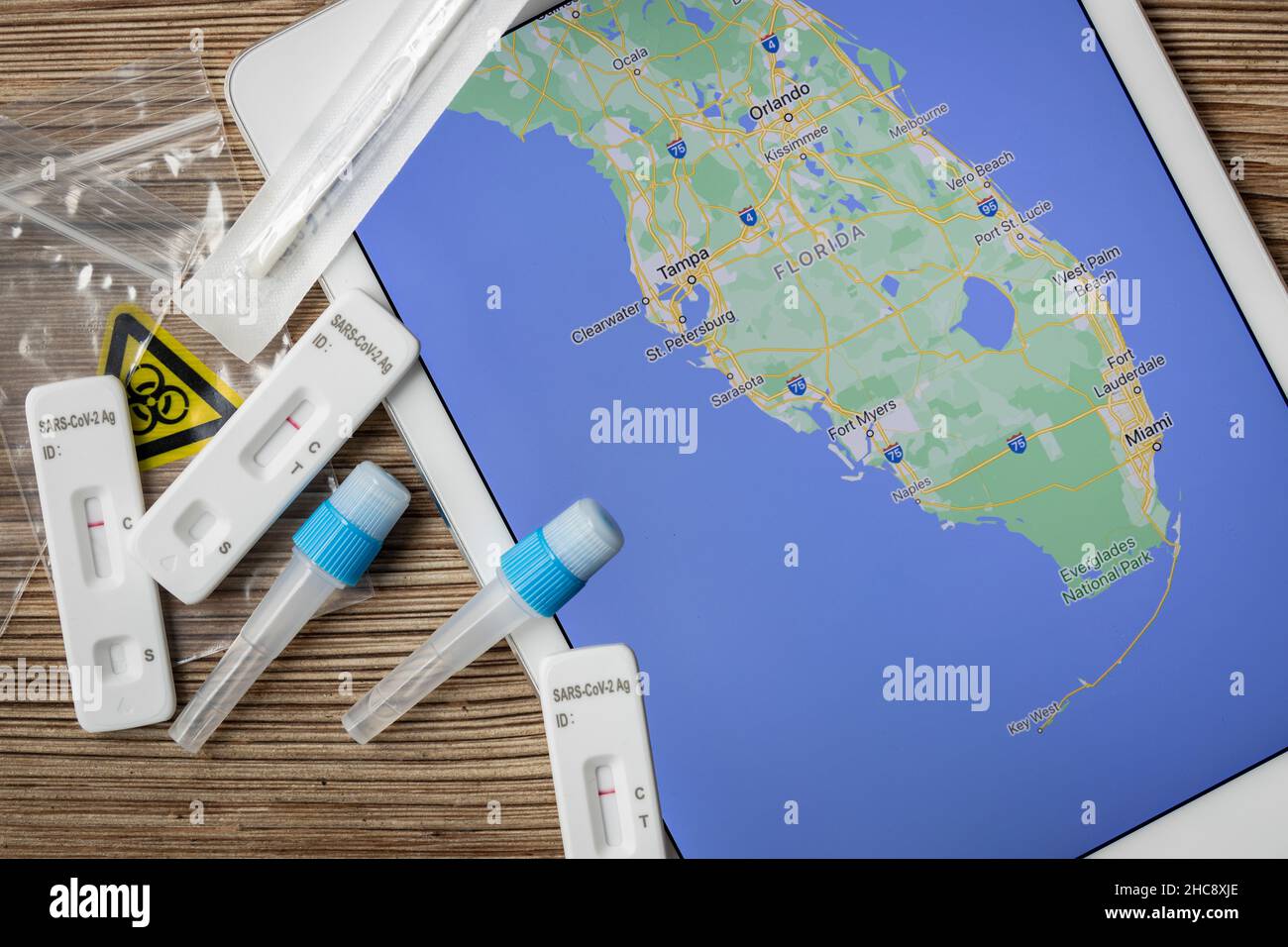 Covid home testing kits laying on a table next to a map of Florida ...