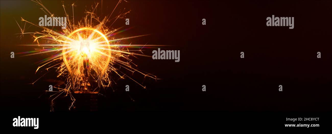 Electricity Spark with bulb on black background Stock Photo - Alamy
