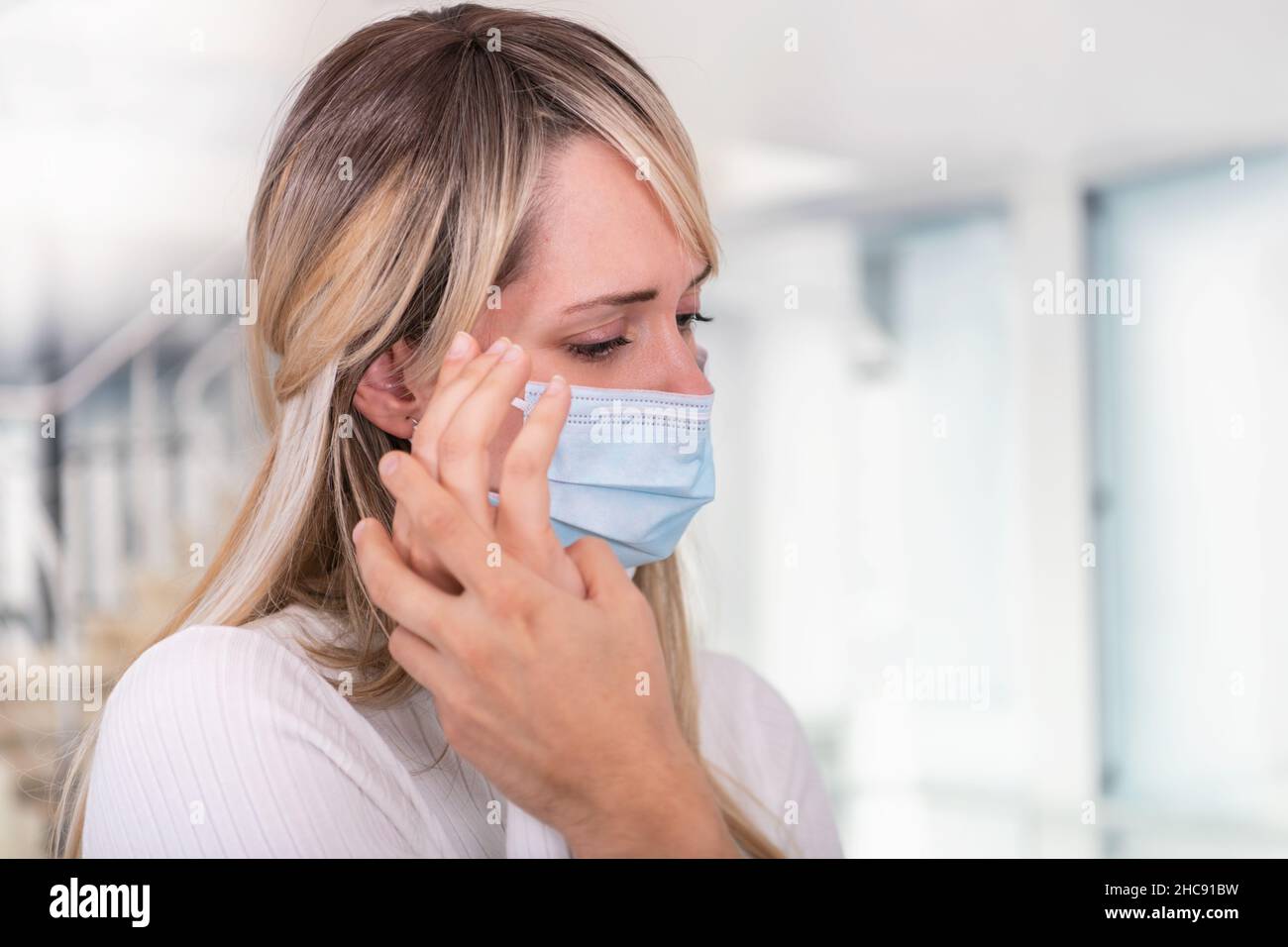 Sad looking woman with face mask being comforted Stock Photo - Alamy