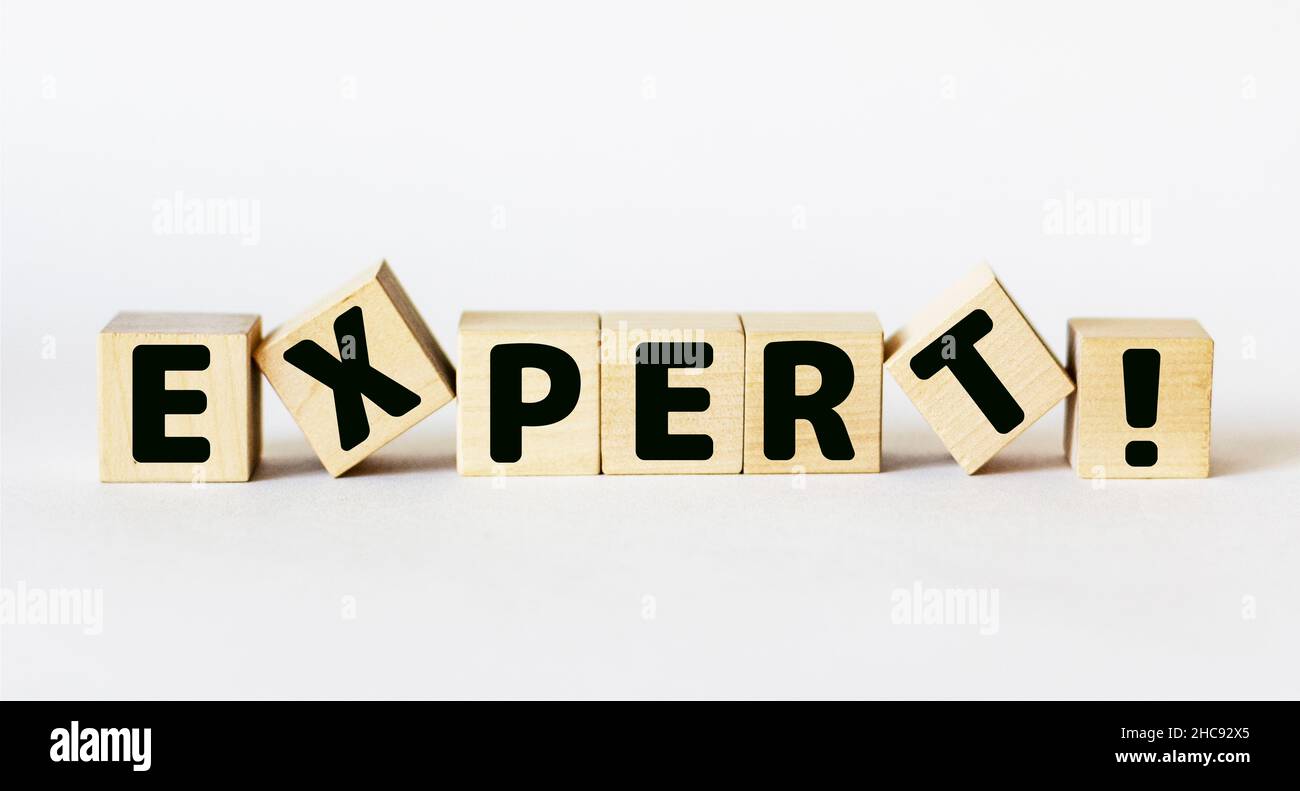 The word expert is written on wooden cubes in a row on a light ...