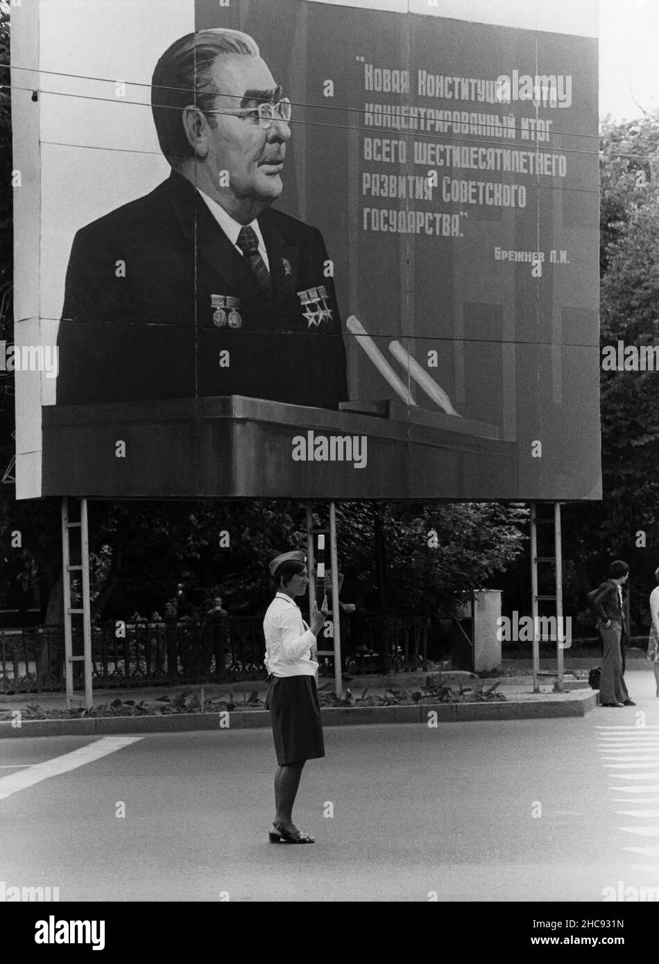 Traffic police in the former Soviet Union with a billboard and slogan ...