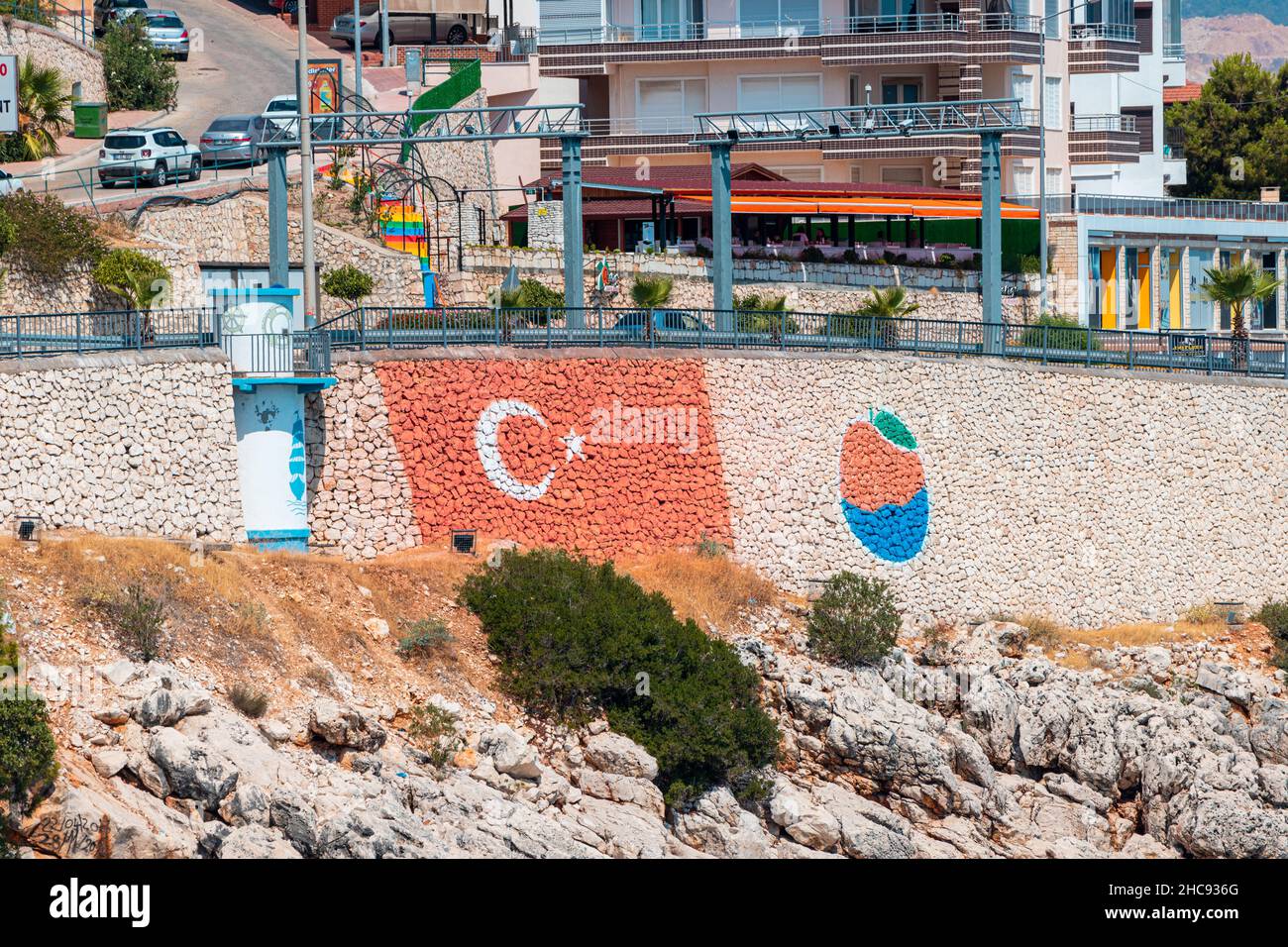 26 August 2021, Finike, Turkey: A resort town with Turkish flag painted ...