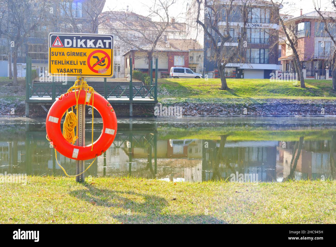 Life Buoy and Warning sign at riverside in a sunny day in Turkey Stock ...