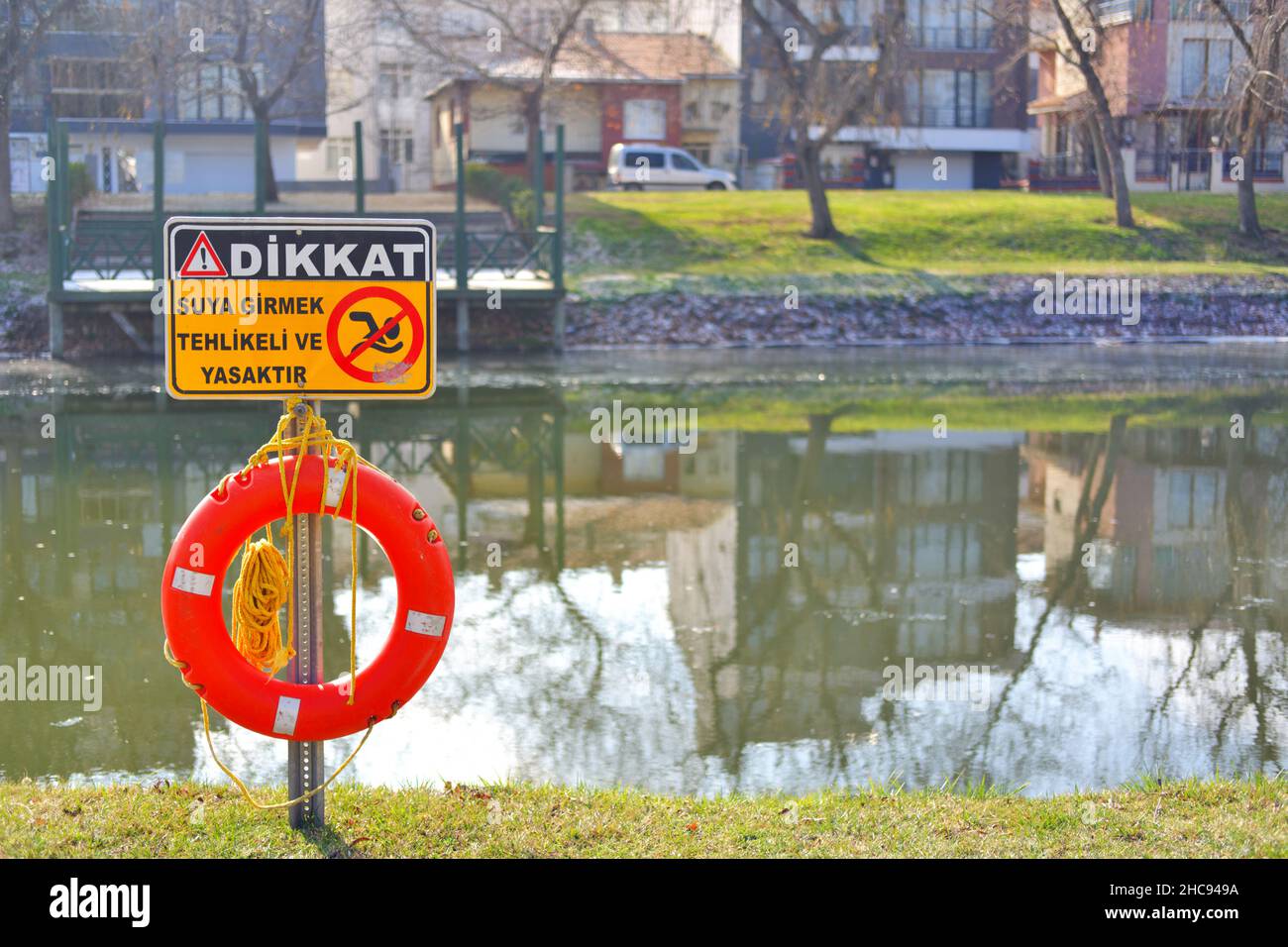 Life Buoy and Warning sign at riverside in a sunny day in Turkey Stock ...