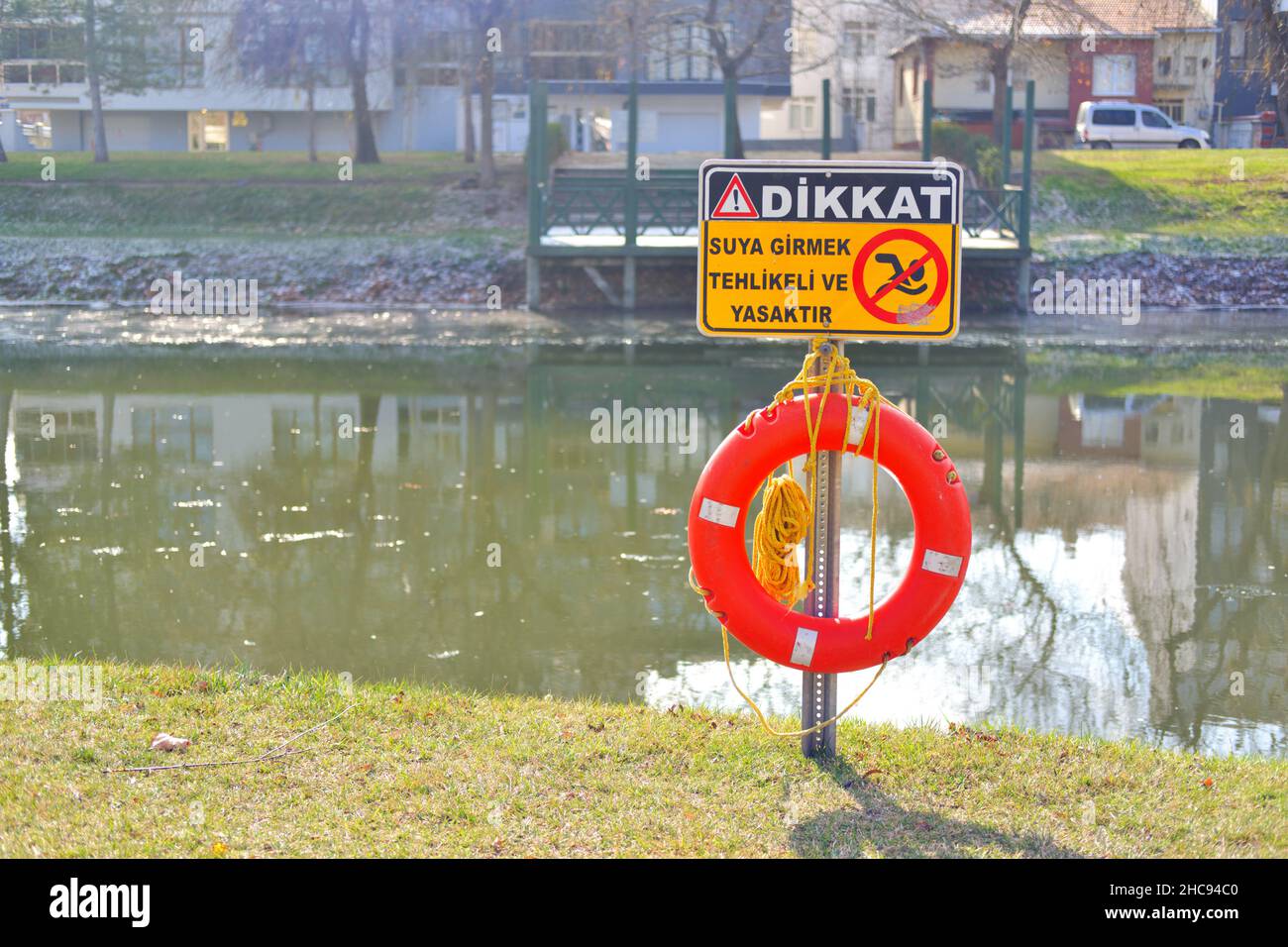 Life Buoy and Warning sign at riverside in a sunny day in Turkey Stock ...