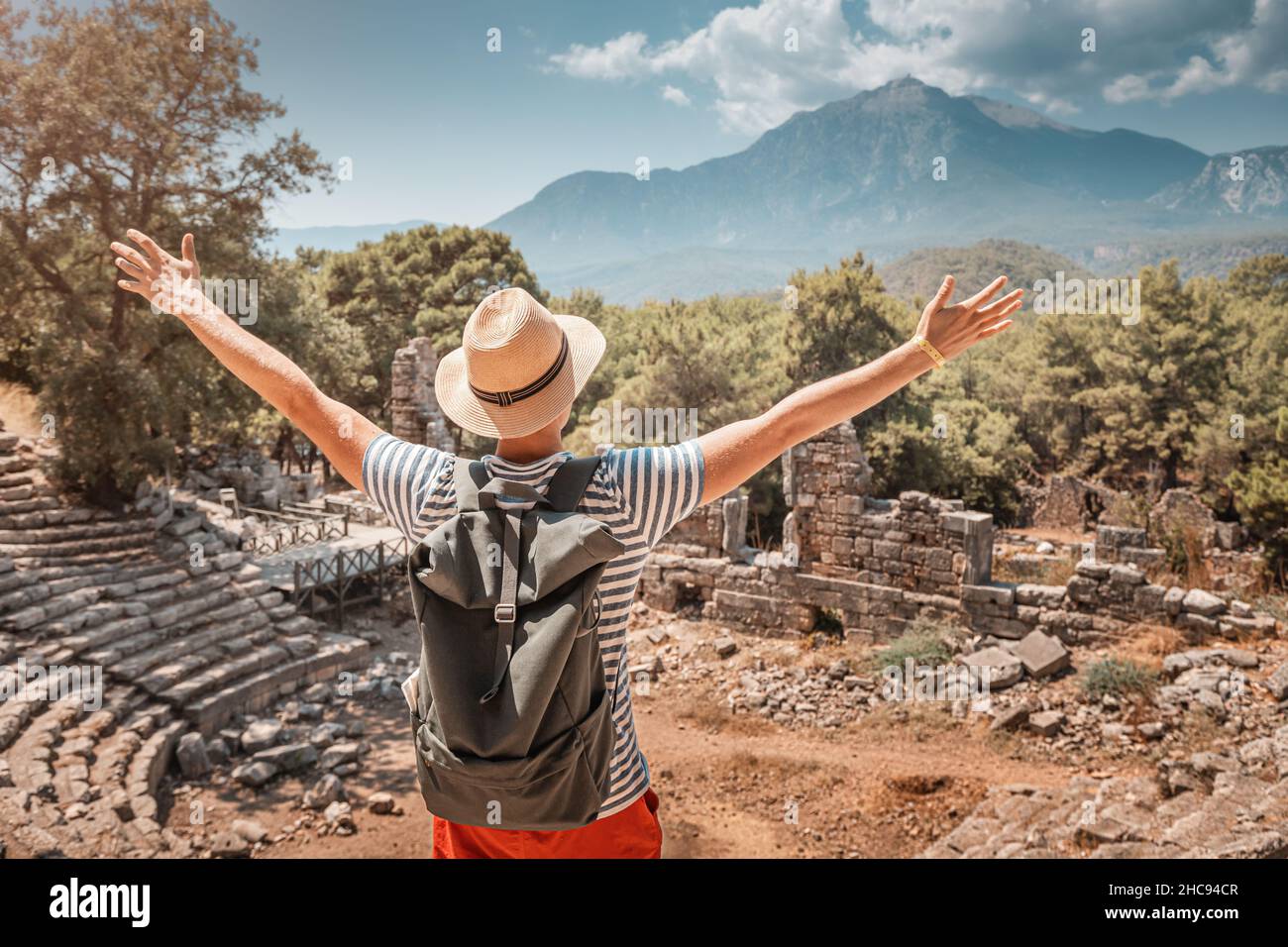 Male traveler explores the ruins of an ancient amphitheatre in antique ...