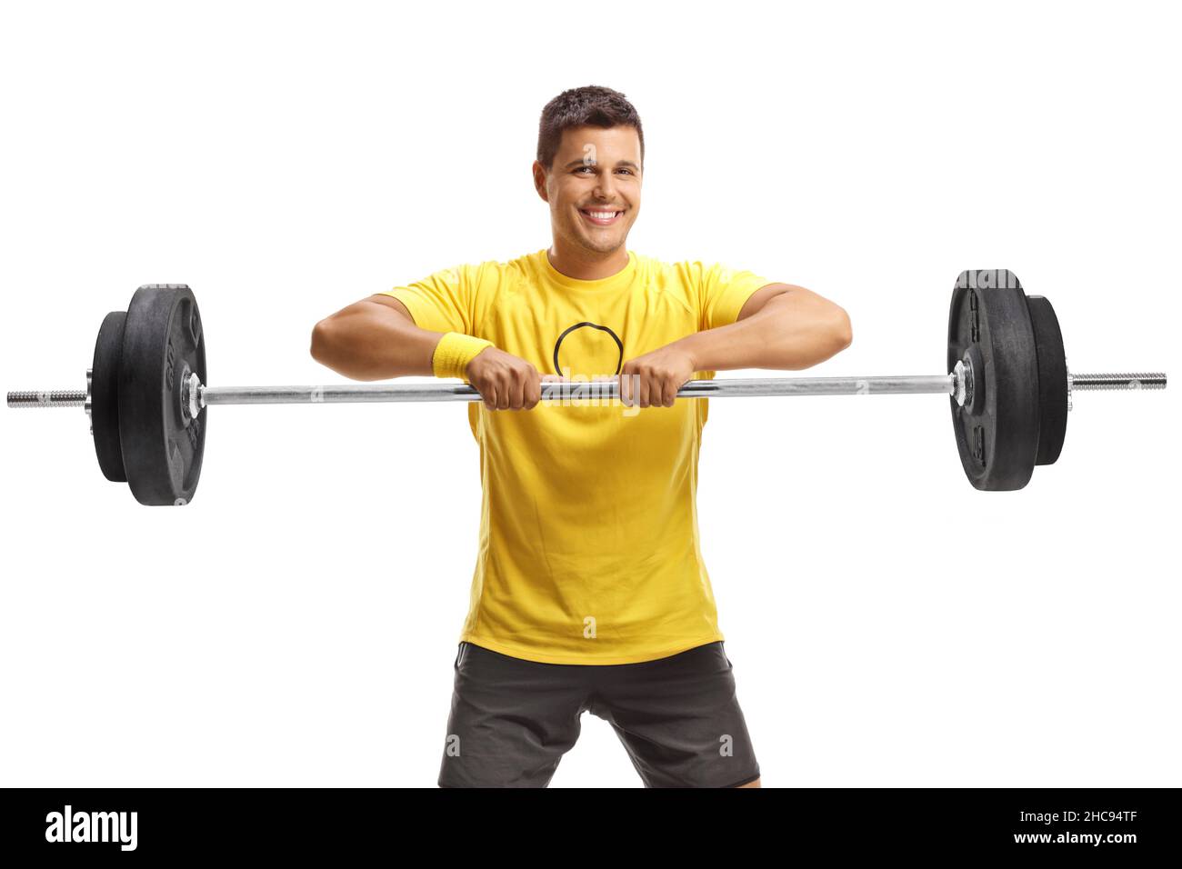 Smiling young man lifting weights isolated on white background Stock ...