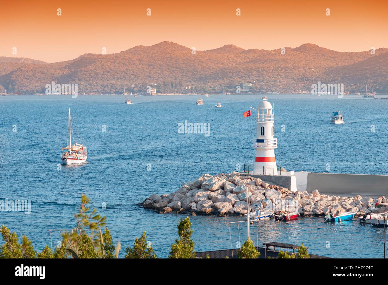 Romantic lighthouse at the entrance to the bay and port of Kas on the ...