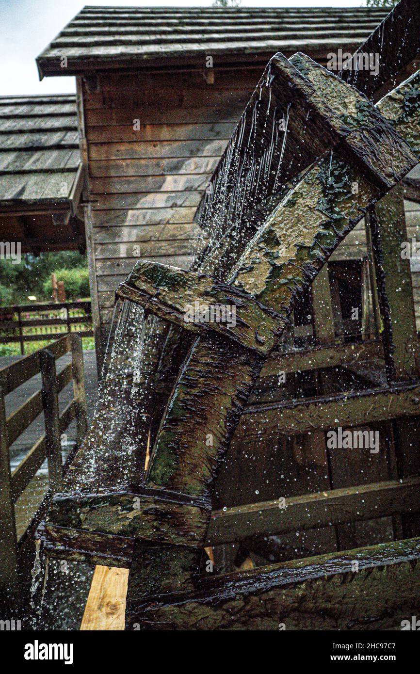 Vertical shot of a vintage watermill in the country house yard Stock ...