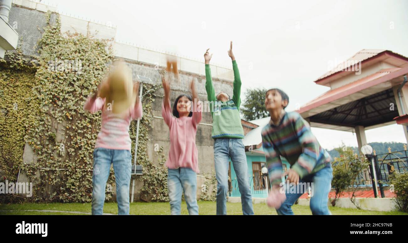 Low angle shot of a group of Indian kids jumping in slow motion on the ...