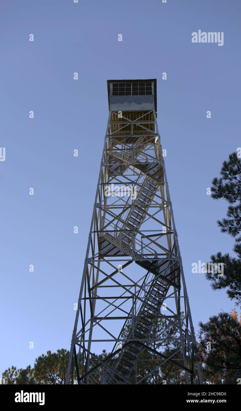 Low angle shot of a forest fire observation tower under the blue sky ...