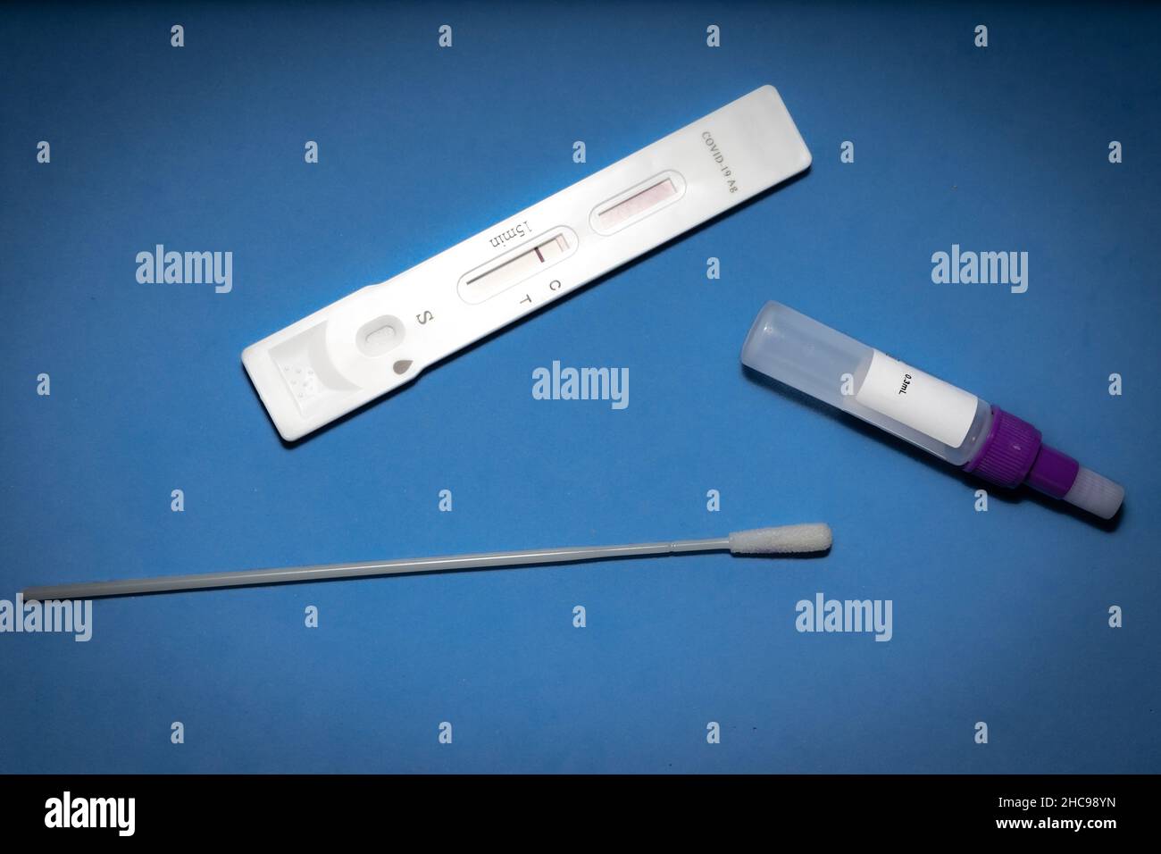 Negative Covid-19 antigen test with swab and liquid tube on blue ...