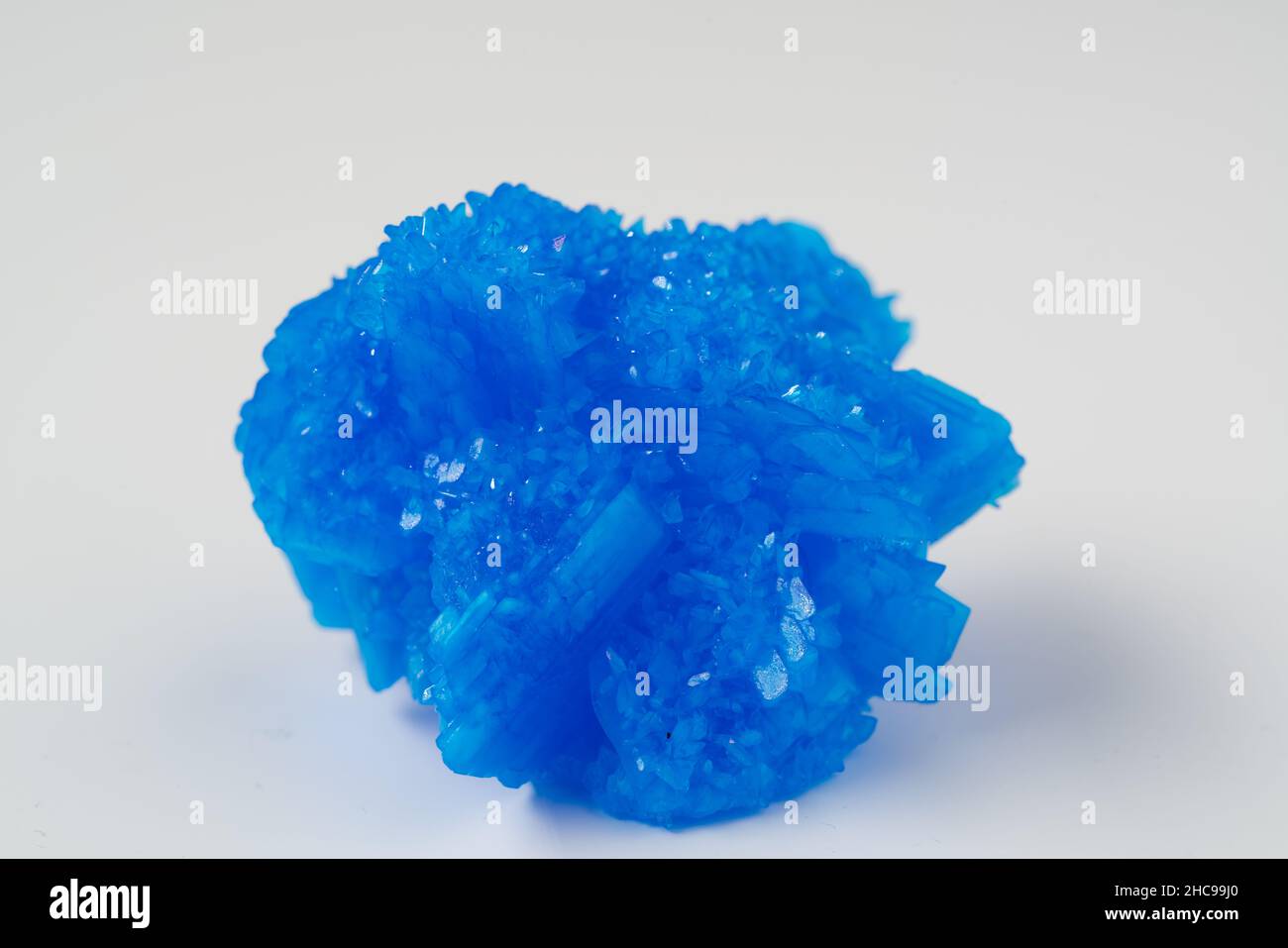 Crystal of copper sulfate on a white background Stock Photo - Alamy