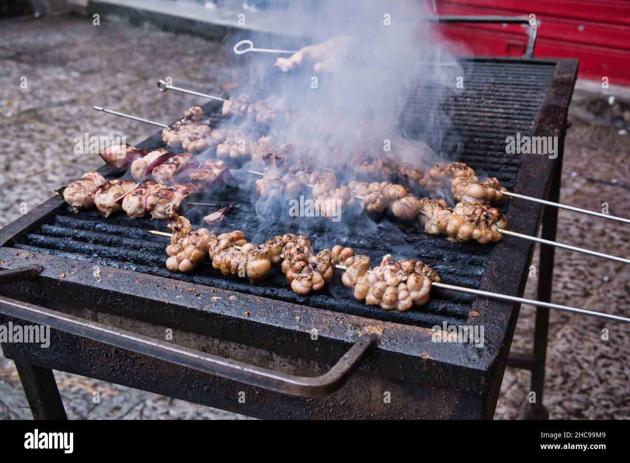 Close-up view of the Stigghiola on the grill a typical street food of ...
