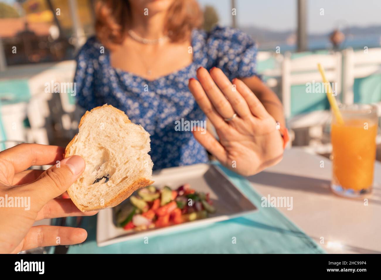 A woman refuses bread toast in a restaurant. Intolerance and allergy to ...