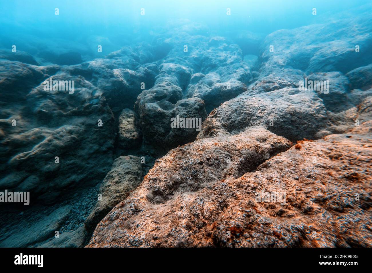A deserted but fascinating underwater landscape with large rocks ...