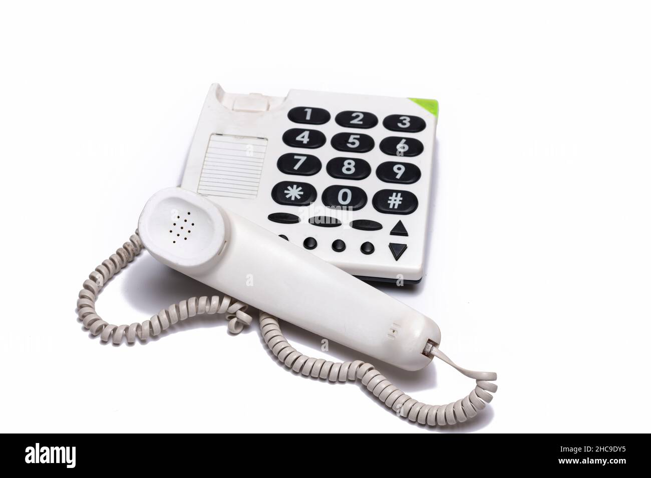 Close up of white landline phone with large buttons isolated on white ...