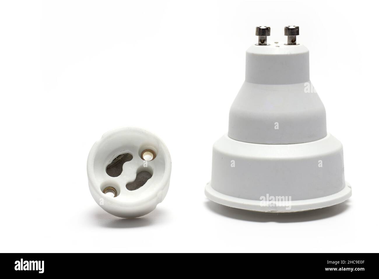 Close up of lamp socket GU10 with matching LED lamp bulb next to it ...