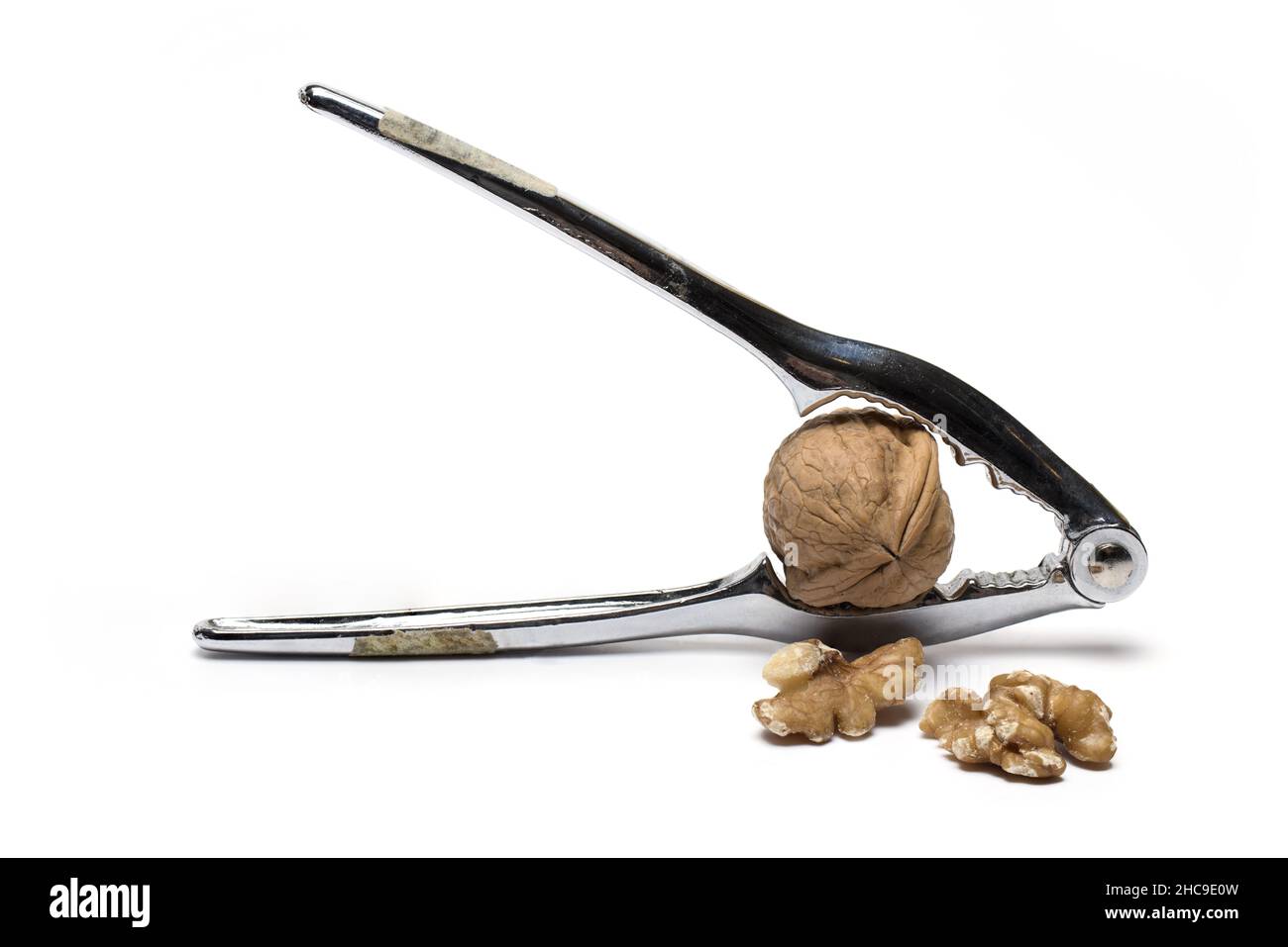 Close up of metal pliers to open nuts with walnut nutcracker isolated ...