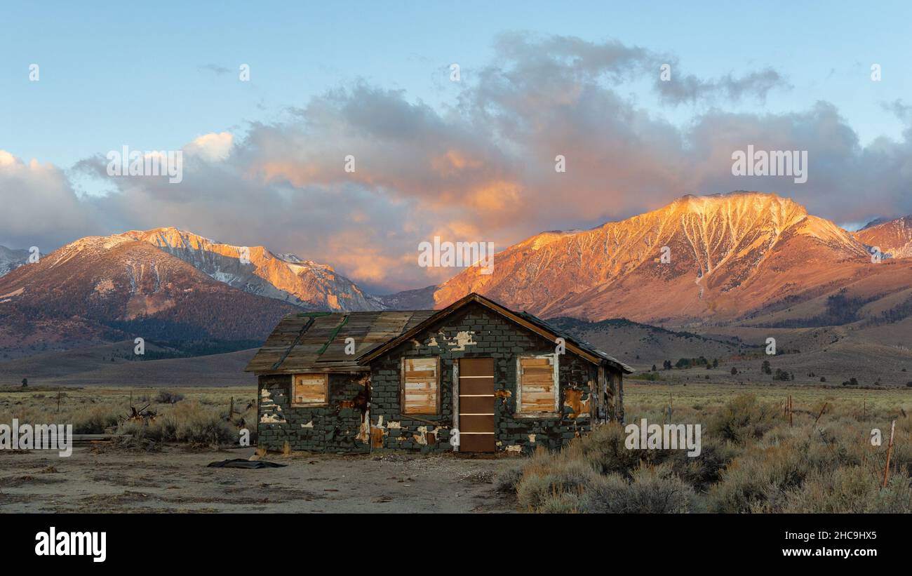 Old abandoned building at sunrise with the Sierra Nevada Mountains in ...