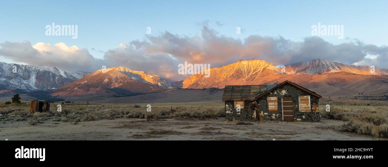 Old abandoned building at sunrise with the Sierra Nevada Mountains in ...