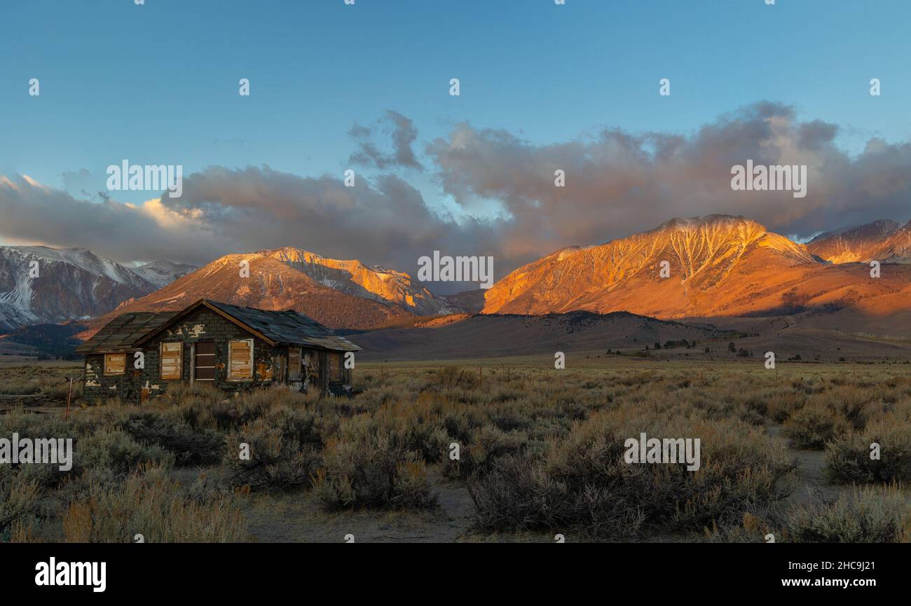 Old abandoned building at sunrise with the Sierra Nevada Mountains in ...