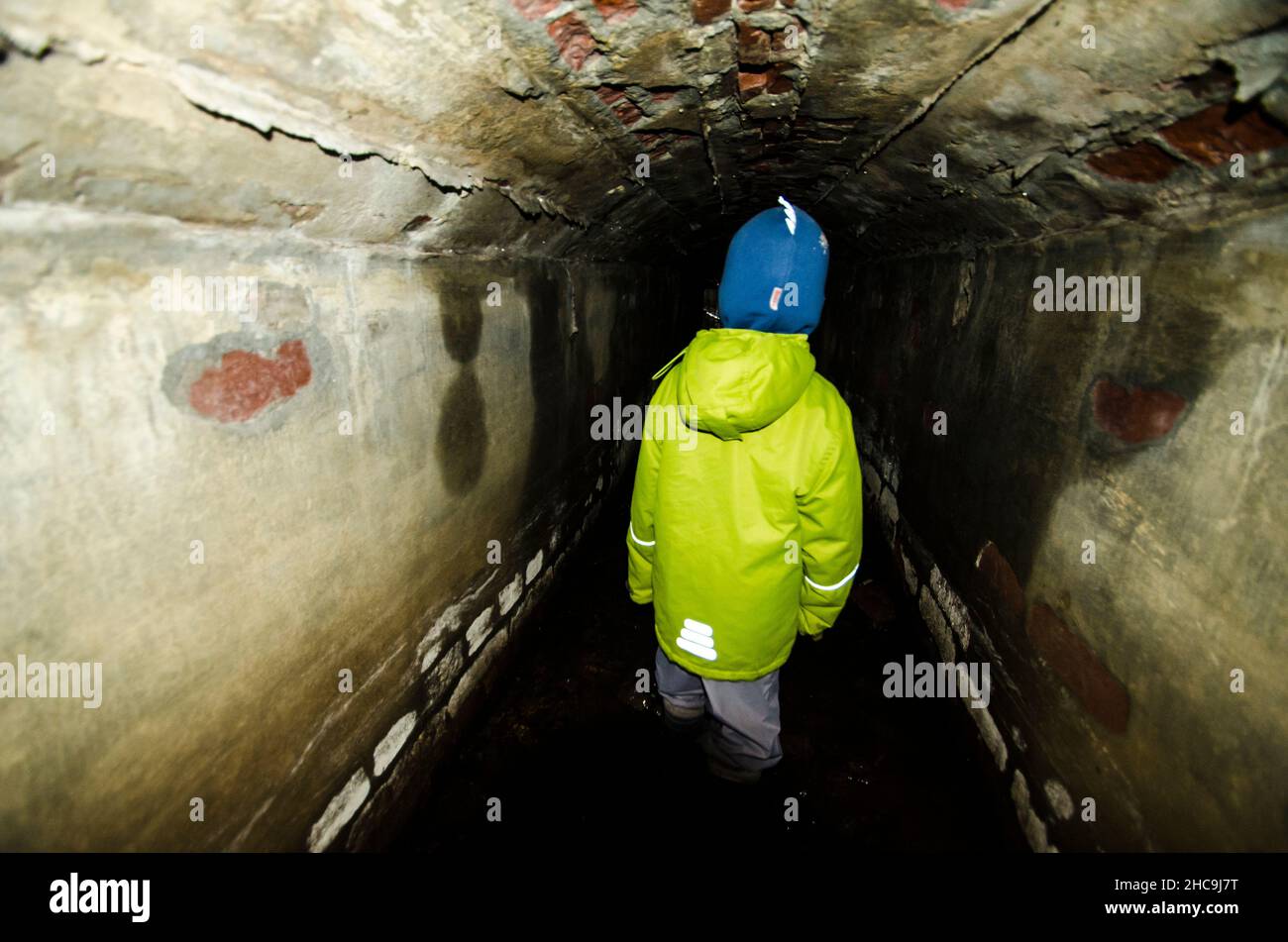 Little boy in the dungeon. Underground passage Stock Photo - Alamy