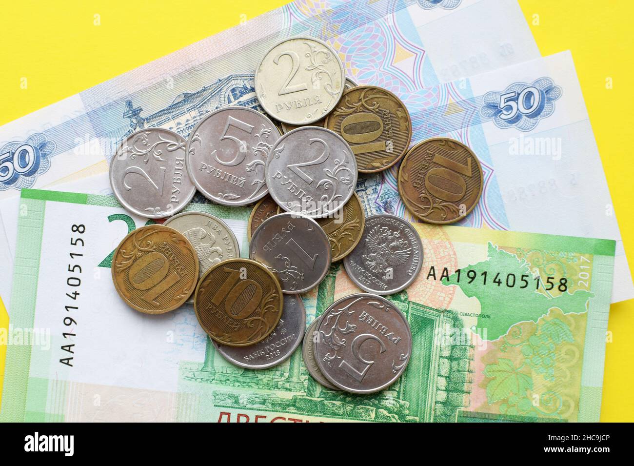 Money of Russia. Banknotes and coins on yellow background. Close-up of ...