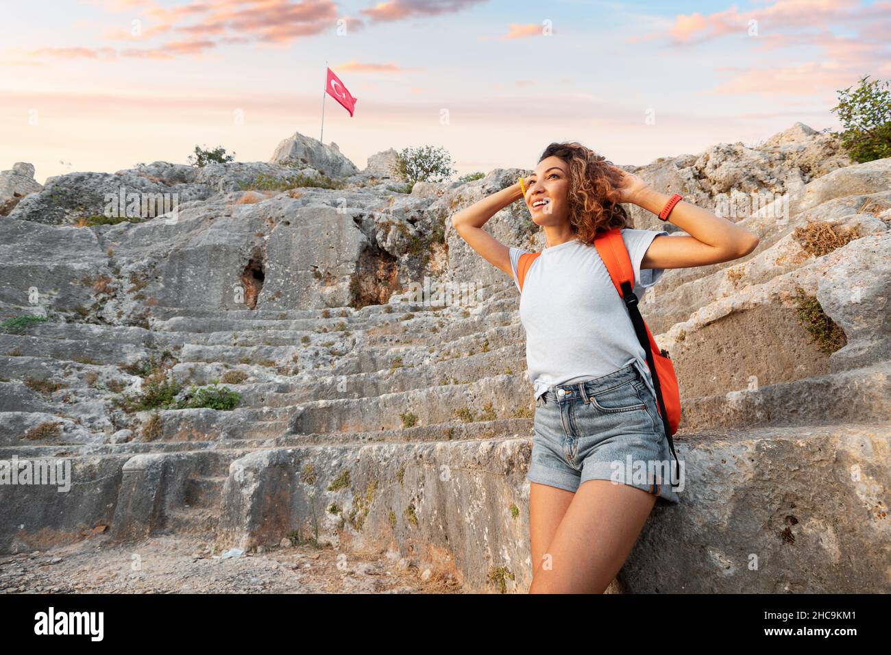 Elegant tourist girl explores ancient landmark and ruins of Greek or ...