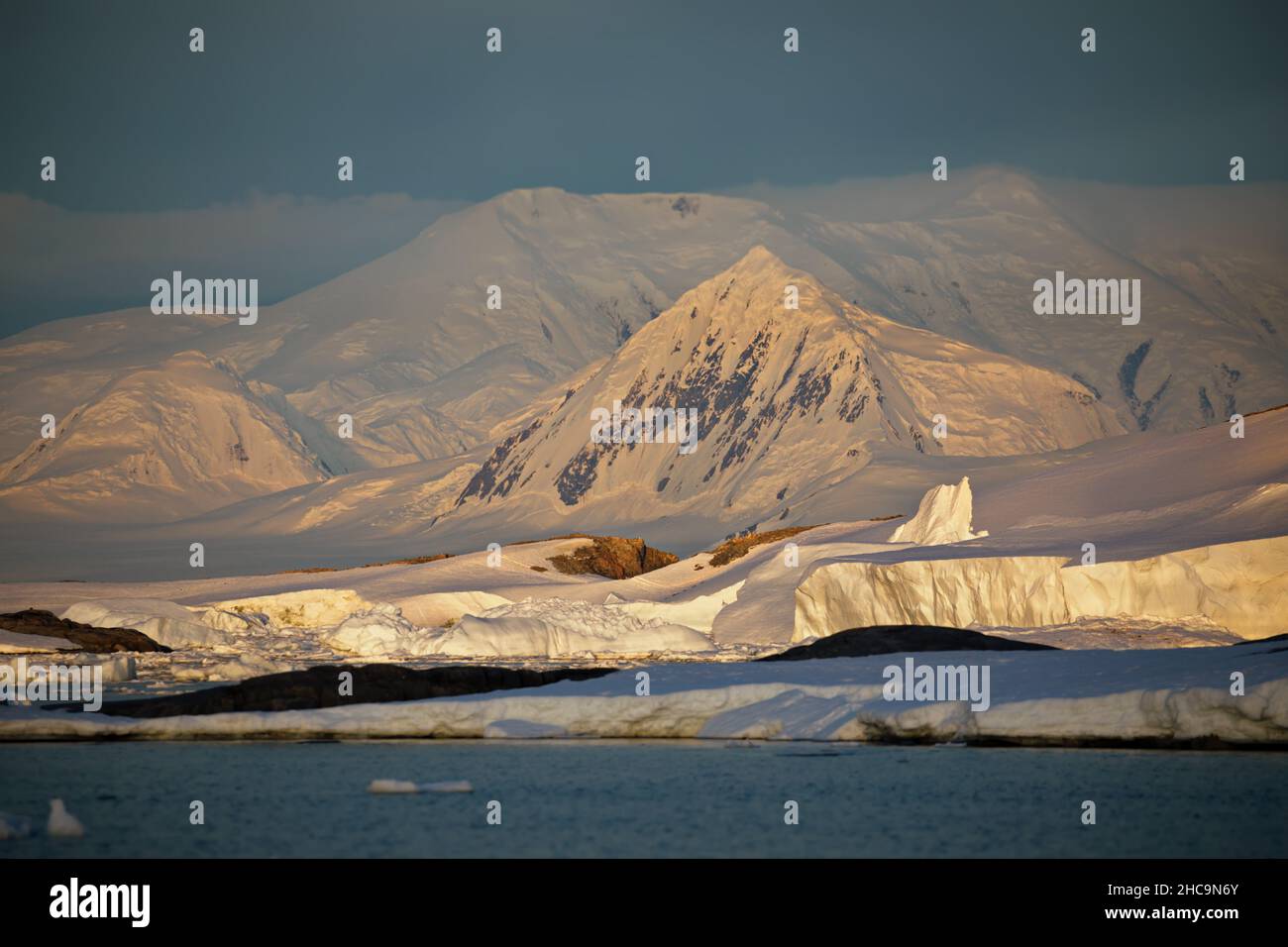 Landscape of the ocean surrounded by hills covered in the ice and snow ...