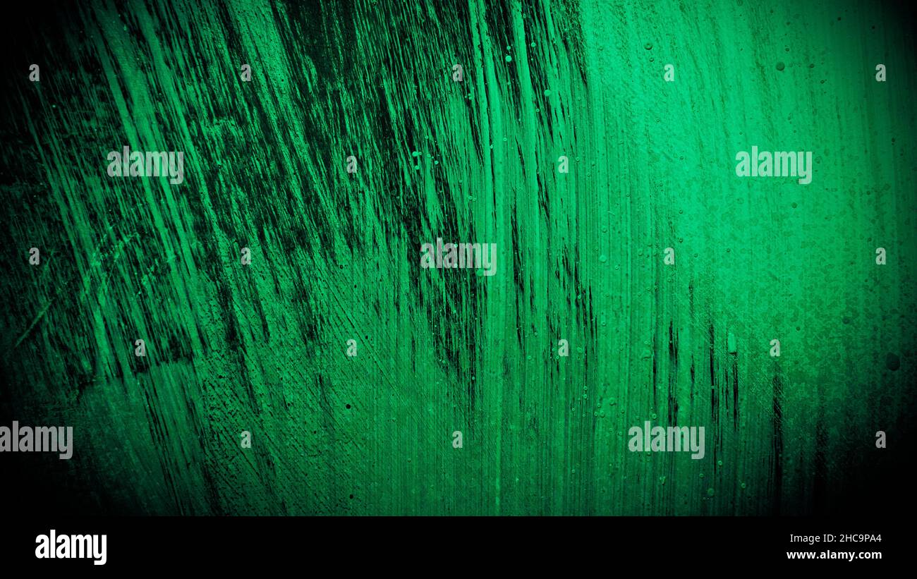 Splashes of acrylic paints on the wall, black and green combination ...