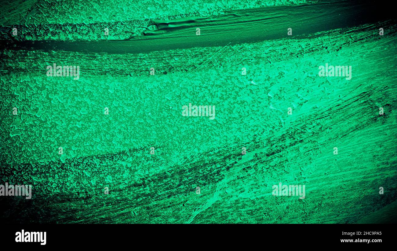 Splashes of acrylic paints on the wall, black and green combination ...