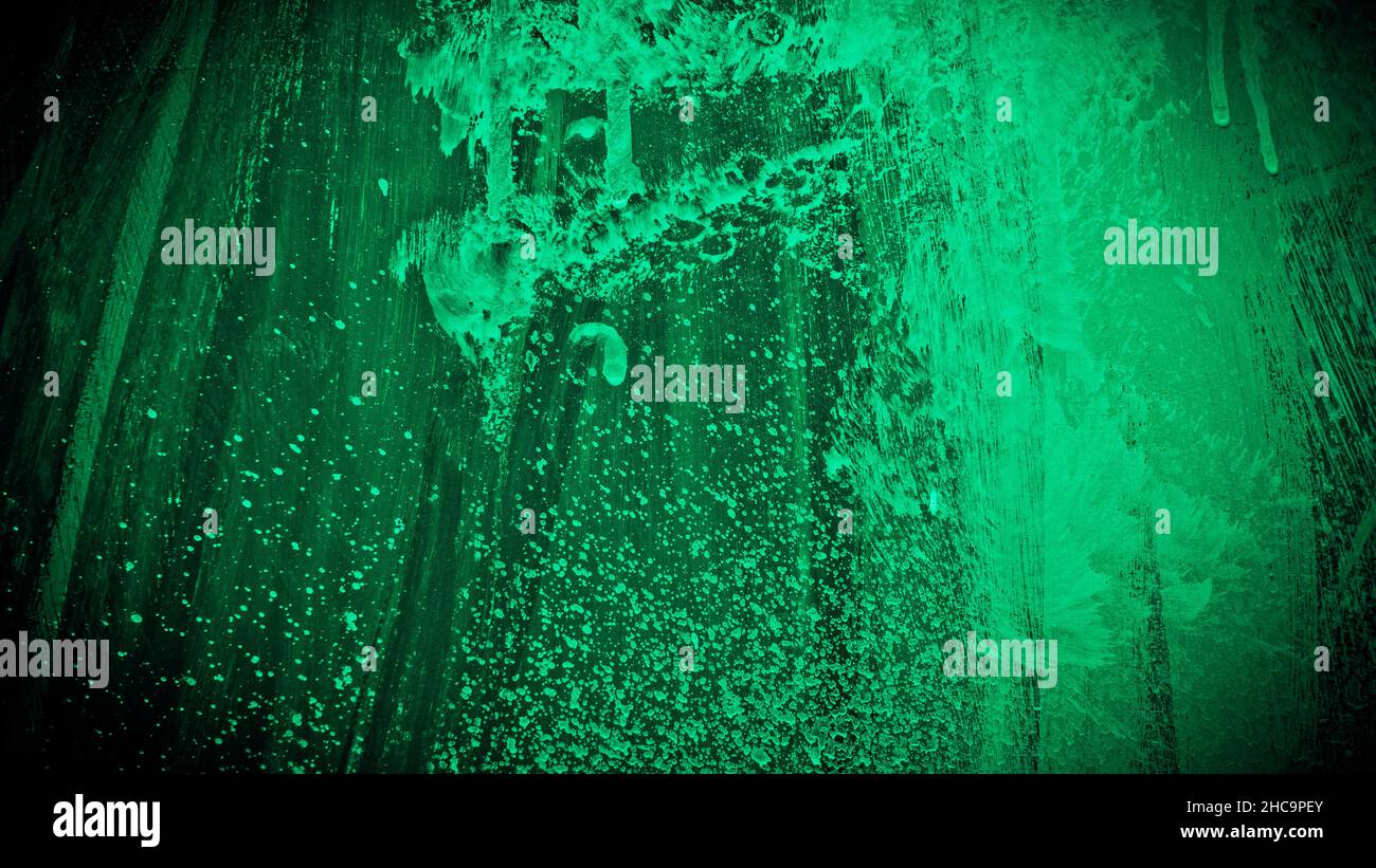 Splashes of acrylic paints on the wall, black and green combination ...