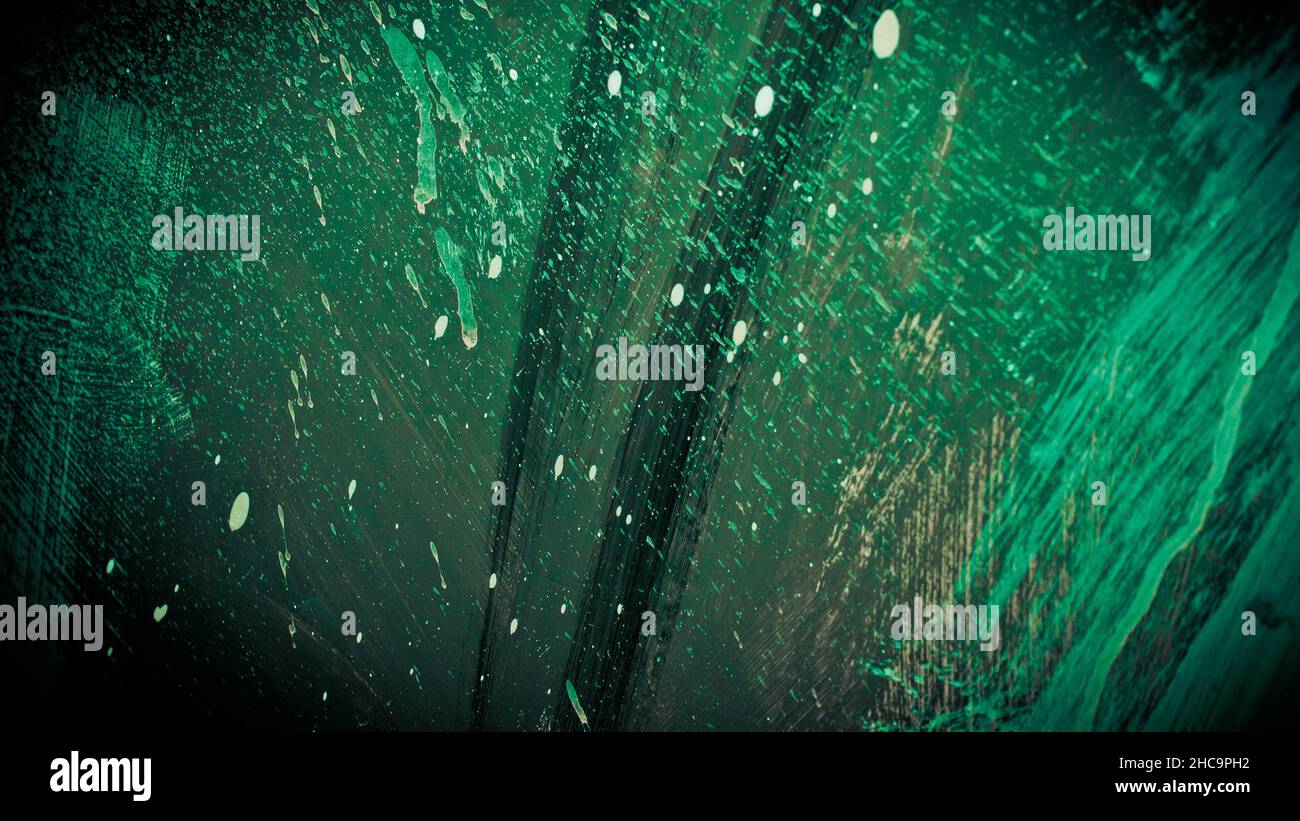 Splashes of acrylic paints on the wall, black and green combination ...